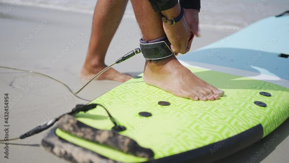 4K Confidence Asian man in wetsuit wear surfboard safety leg rope ...