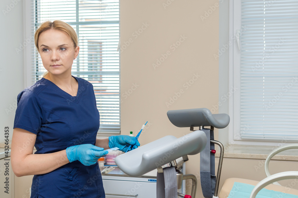gynecologist stands at a gynecological chair with brushes for taking an ...
