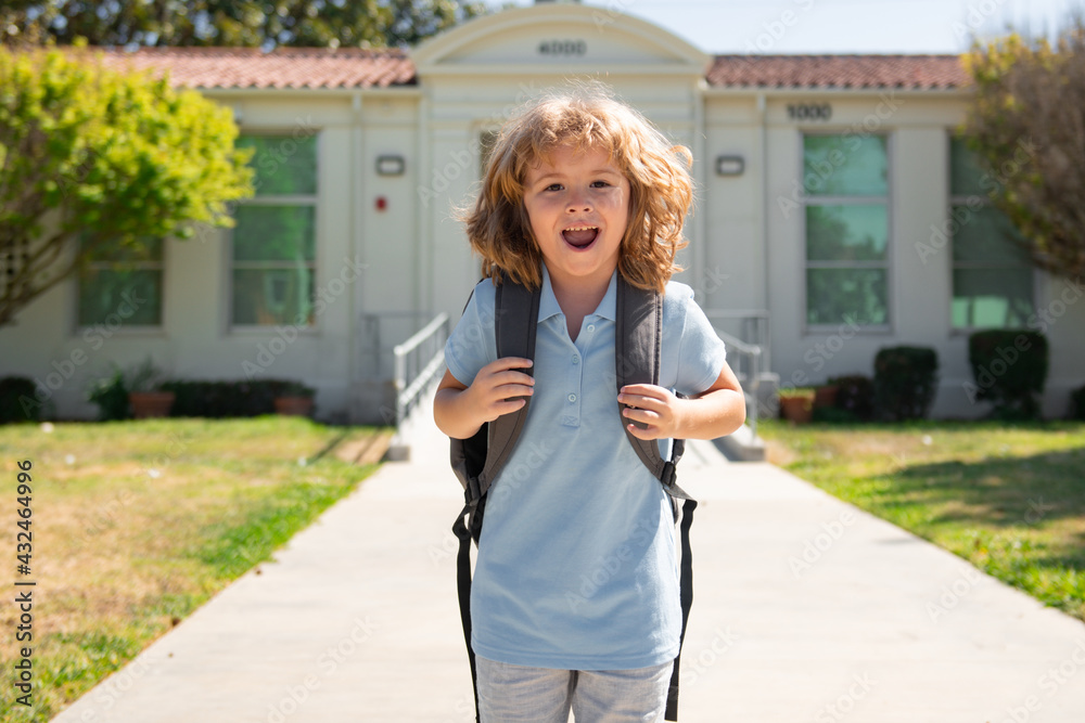 Happy amazed excited kid is going to school. Child boy with bag go to ...