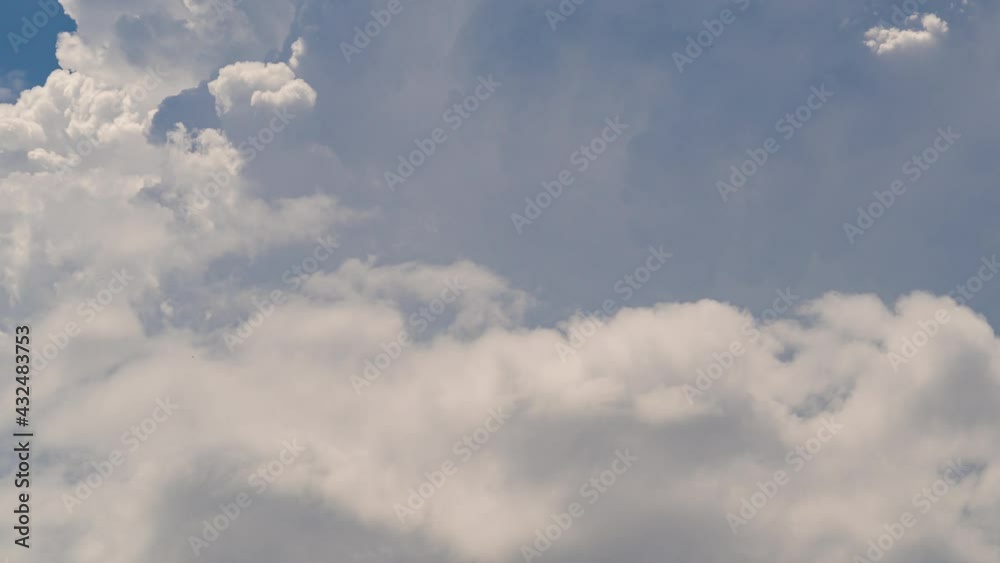 Blue sky white Puffy fluffy Cumulus clouds billow in high space. Summer blue sky timelapse ...