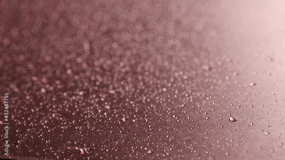 Copper. Metal plates. Drops of water are sprayed onto copper coating ...