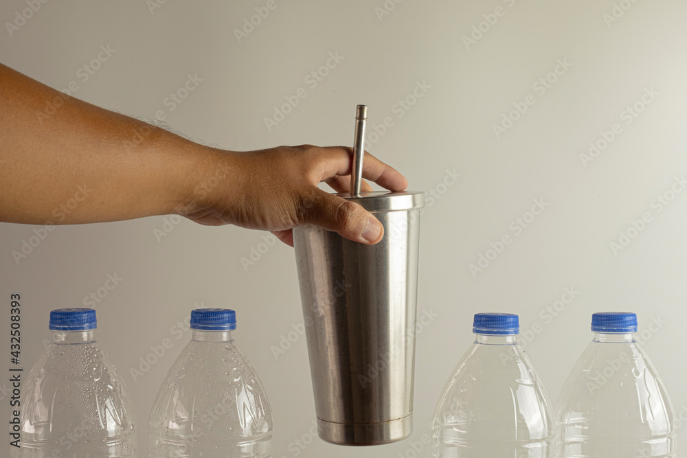 Man Choosing eco tumbler among plastic bottle over white background ...