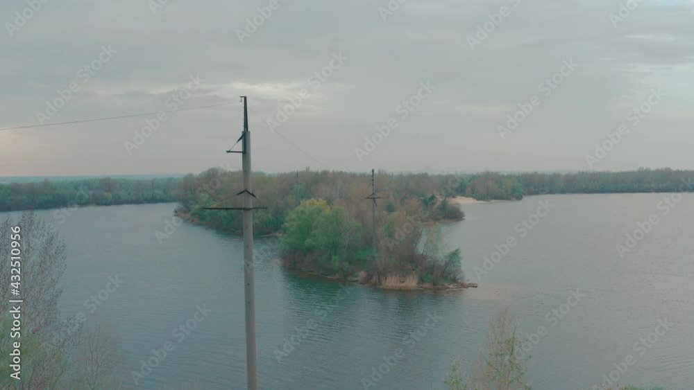 high voltage electrical wires run over water. electrical network along ...