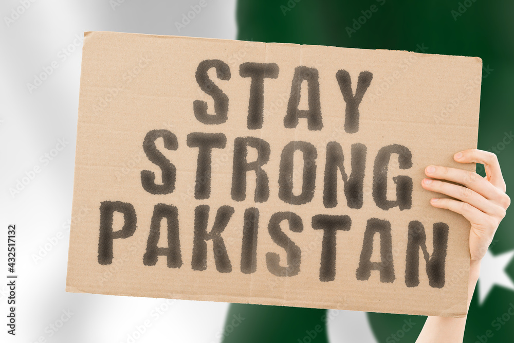 The phrase " Stay strong Pakistan " on a banner in men's hand with ...