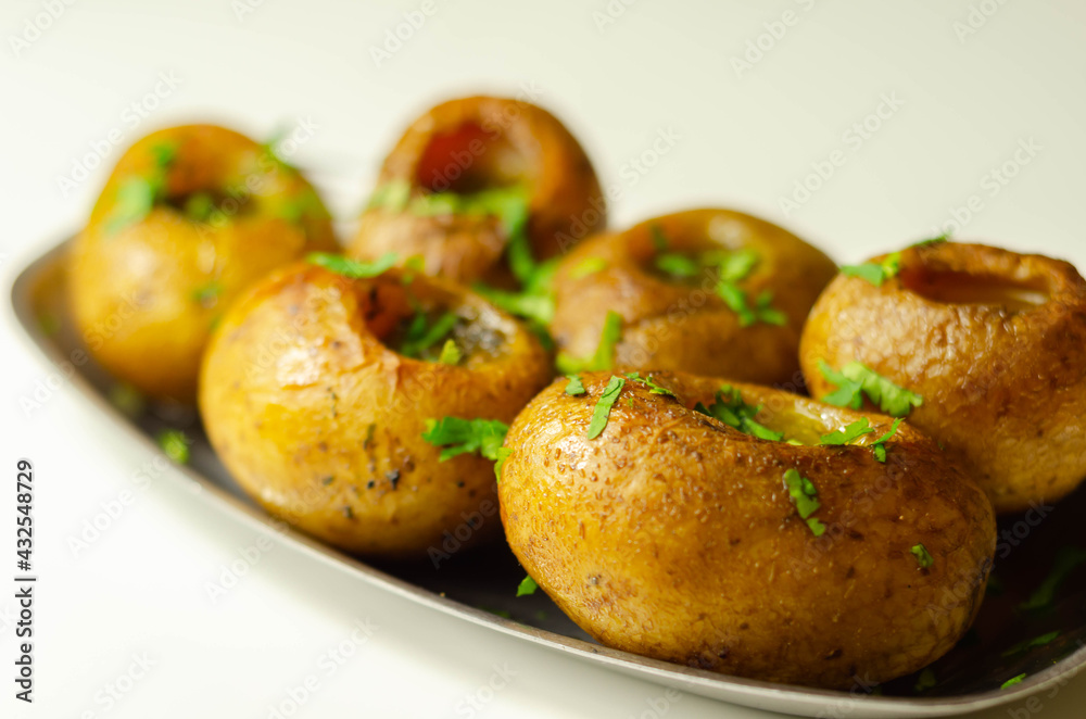 Mini jacket potatoes with a fragrant garlic butter infused with Italian ...