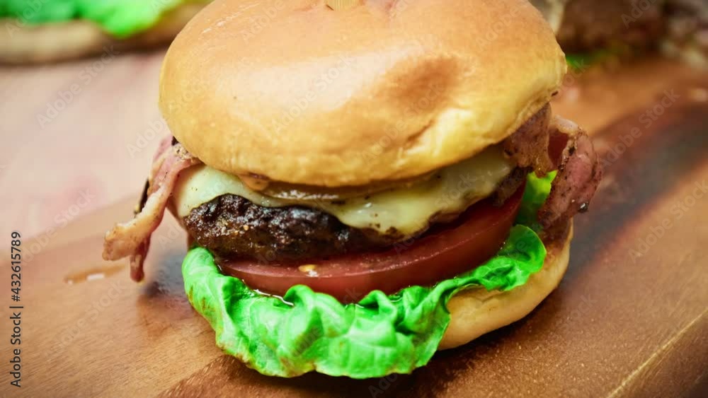 Close-up look of a beef burger in 4K in slow-motion. Concept of a beef ...