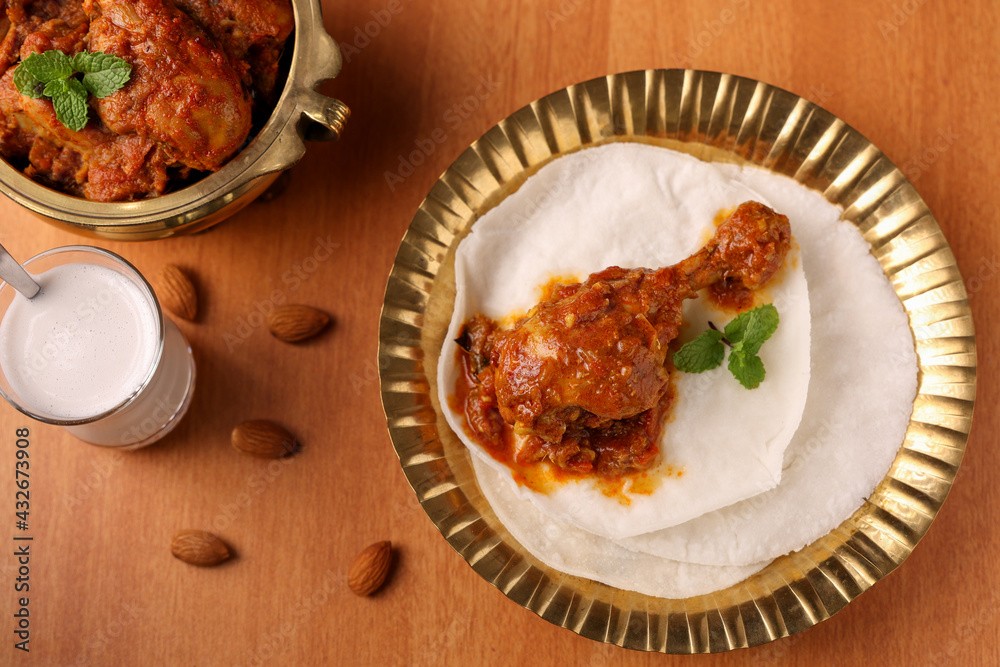 Rice Pathiri flat bread with spicy chicken leg curry golden plate ...