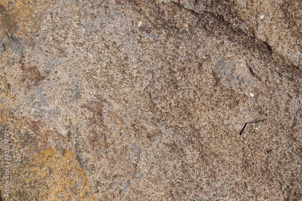 Brown andesite stone surface texture. Brown-grey rock with cracks and ...