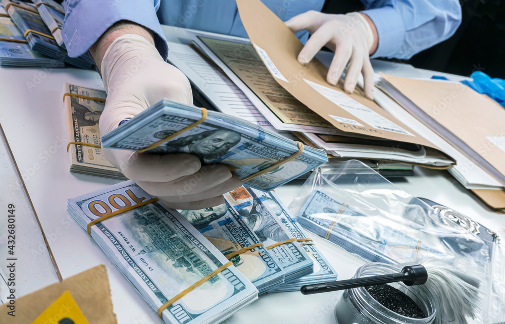 Specialised police officer notes dollar banknote reference of a robbery ...