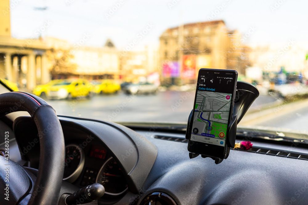 Fotografia do Stock: Using waze maps application on smartphone in car ...