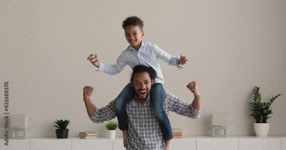 5s son sit on dad shoulders showing biceps, arms strength. Nutritional ...