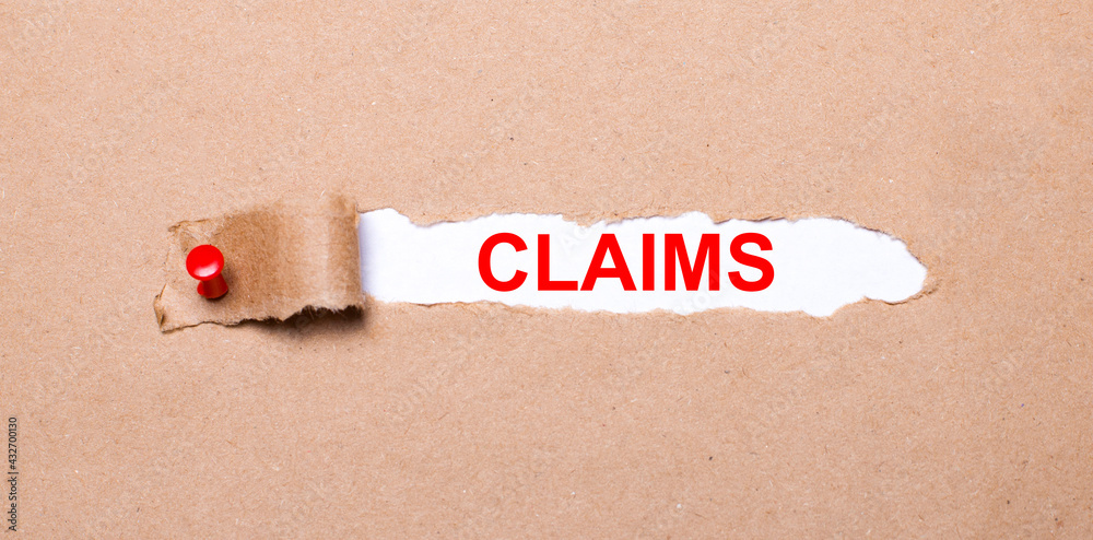 Beneath the torn strip of kraft paper attached with a red button is a ...