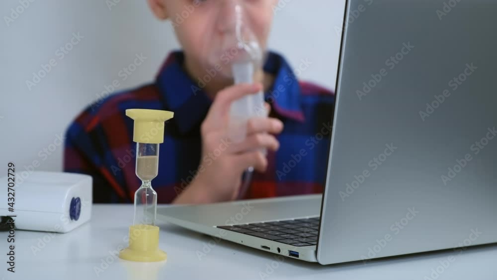 Wideo Stock: Boy is breathing in mask using nebulizer for inhalation at ...