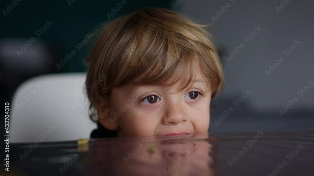 Baby toddler hypnotized by screen, kid biting table while watching ...
