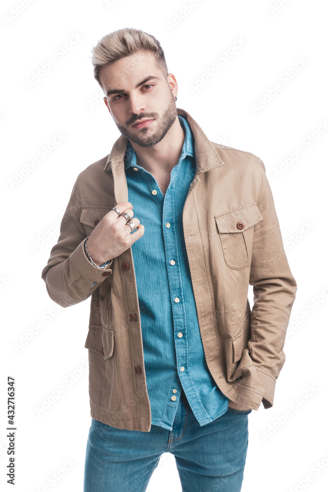 sexy young casual guy in denim shirt pulling jacket and smiling Stock ...