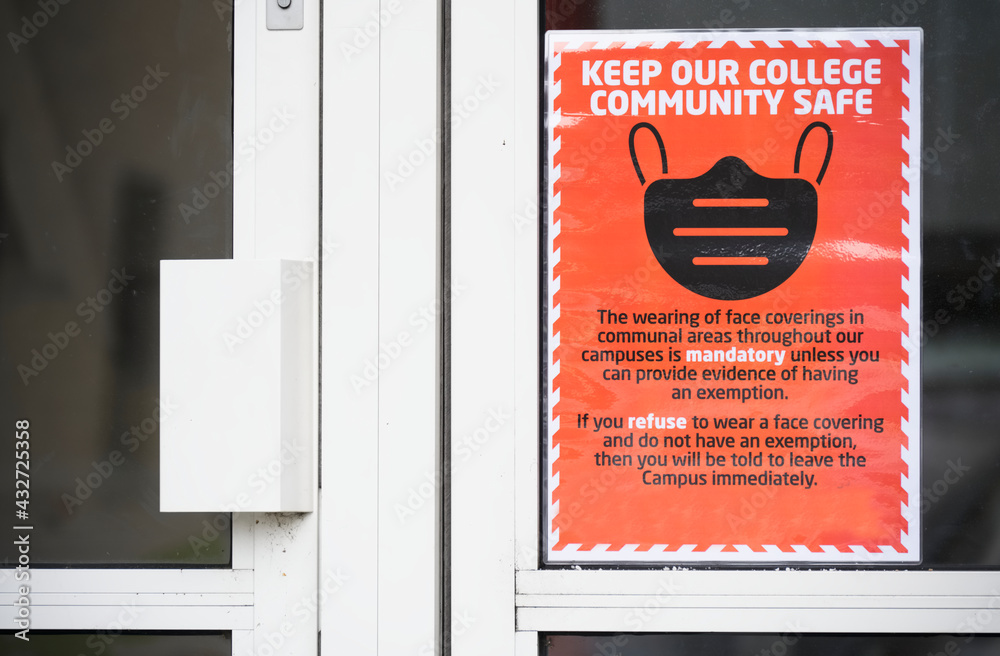 Cover your face using a mask sign at school college door Stock Photo ...