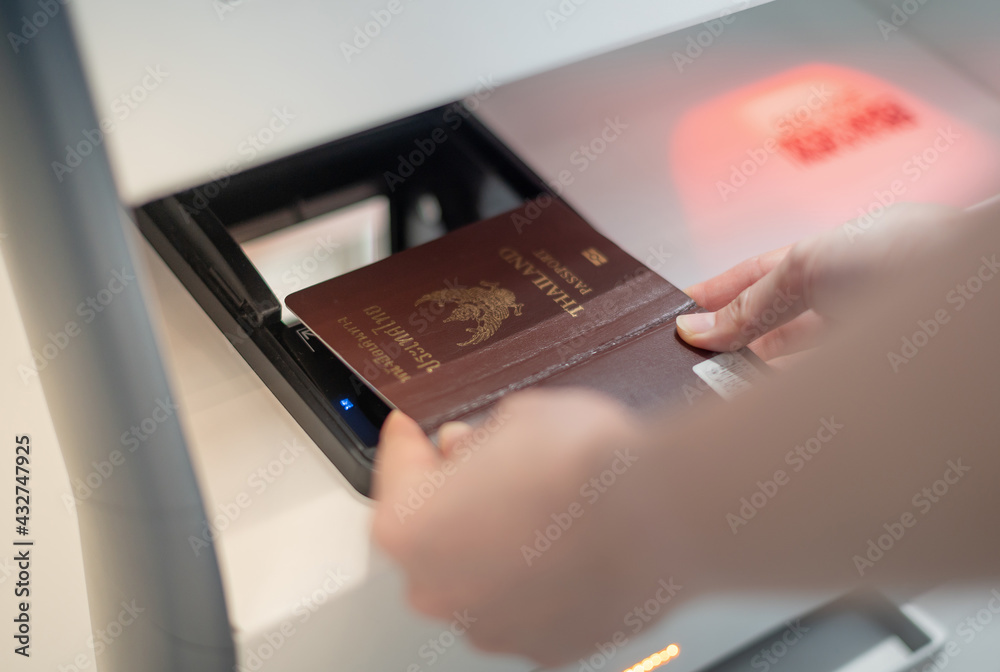 Foto de Female hand holding personal passport scaning at the self ...