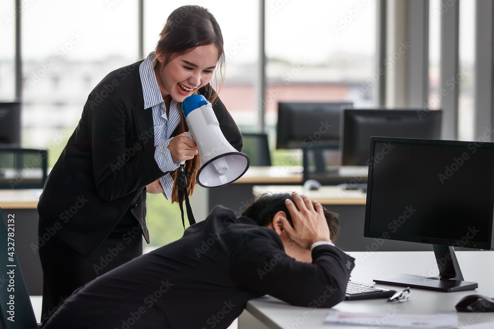 An angry young business woman shouting on a megaphone to wake her lazy ...