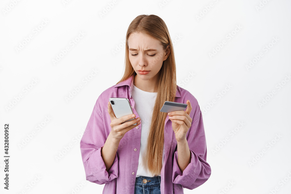 Sad girl holding credit card, looking at empty bank account on ...