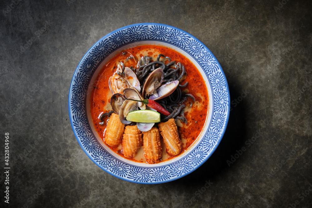 Typical hot ramen dish with fish broth in a bowl with black noodles ...