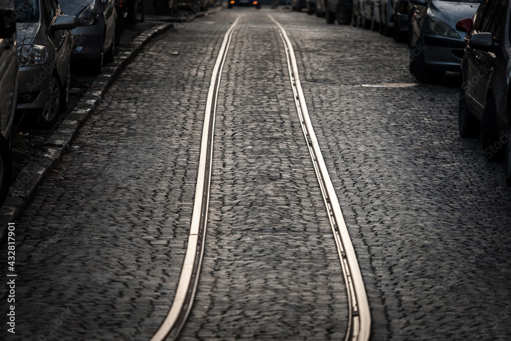 Close up on a tramway rail track on a cobblestone pavement on an old ...
