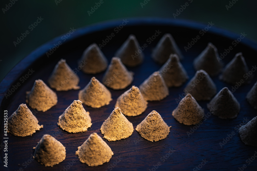 The conical moxa used for treatment is placed in a wooden dish. Moxa ...