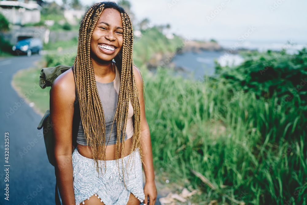 Half length portrait of cheerful hipster girl with trendy dreads ...
