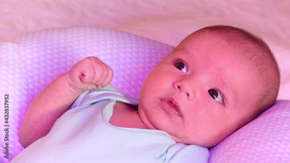 Vidéo Stock Small baby looking intently with a look and a suspicious ...