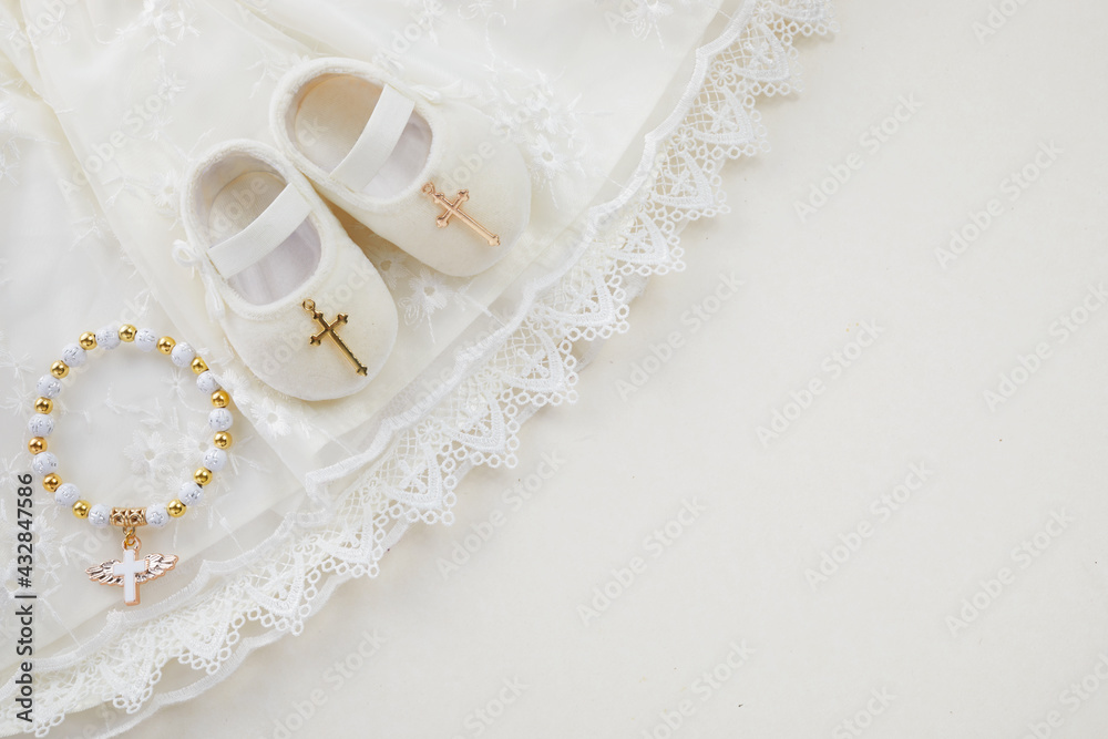 Christening background with baptism baby dress, shoes, and cross on ...