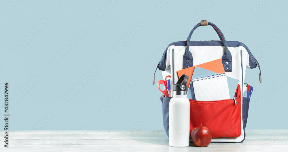 Back to school banner. Backpack with school red and blue stationery ...