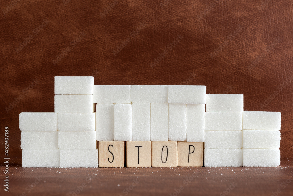 Pile or wall of sugar cubes and stop word in block letters as advise on ...