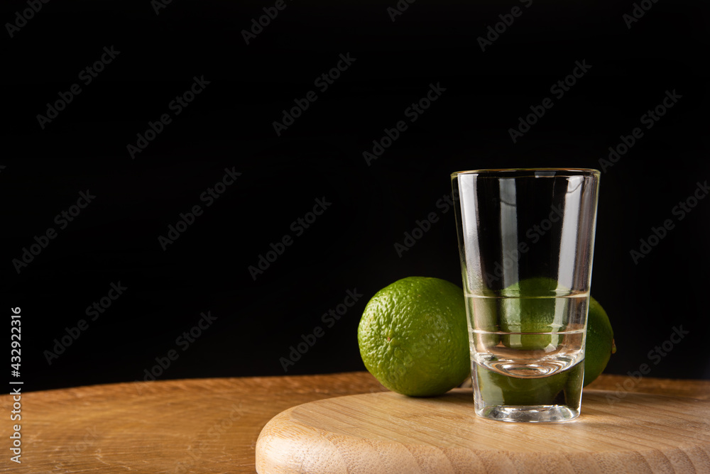 empty Cachaça glass and two lemons, cachaça, drink from sugar cane. It ...