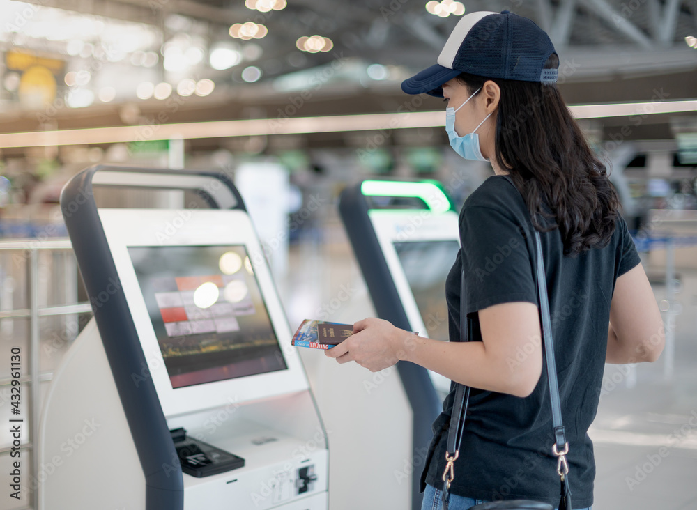Female hand using the auto self service check-in for get the boarding ...