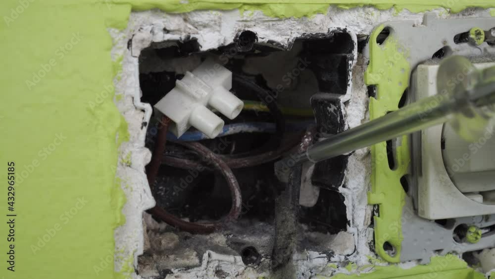 Finding defects in a broken old dangerous wall outlet with dusty wires ...