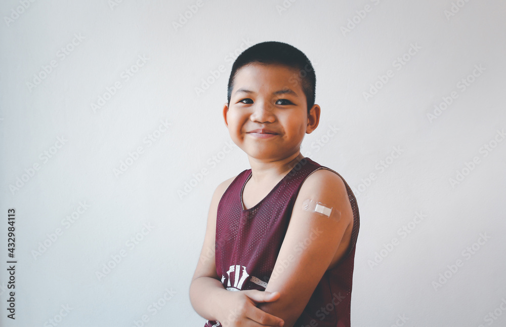 Asian boy showing his arm after getting covid-19 vaccine. Stock Photo ...