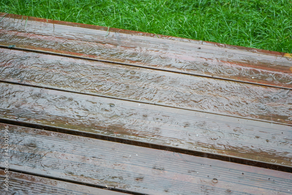 Rain falling on wooden decking boards Stock Photo | Adobe Stock