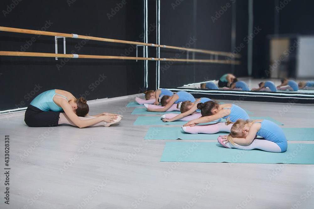 little girls repeat the movements of the teacher in the lesson of the ...