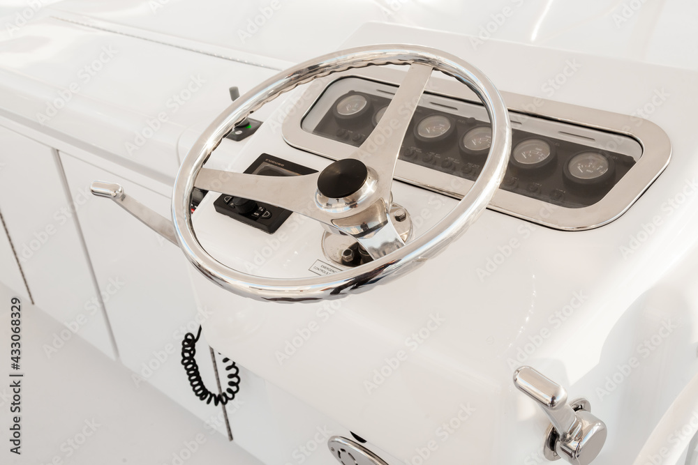 Internal control cabin of a motor yacht. Control panel, steering wheel ...