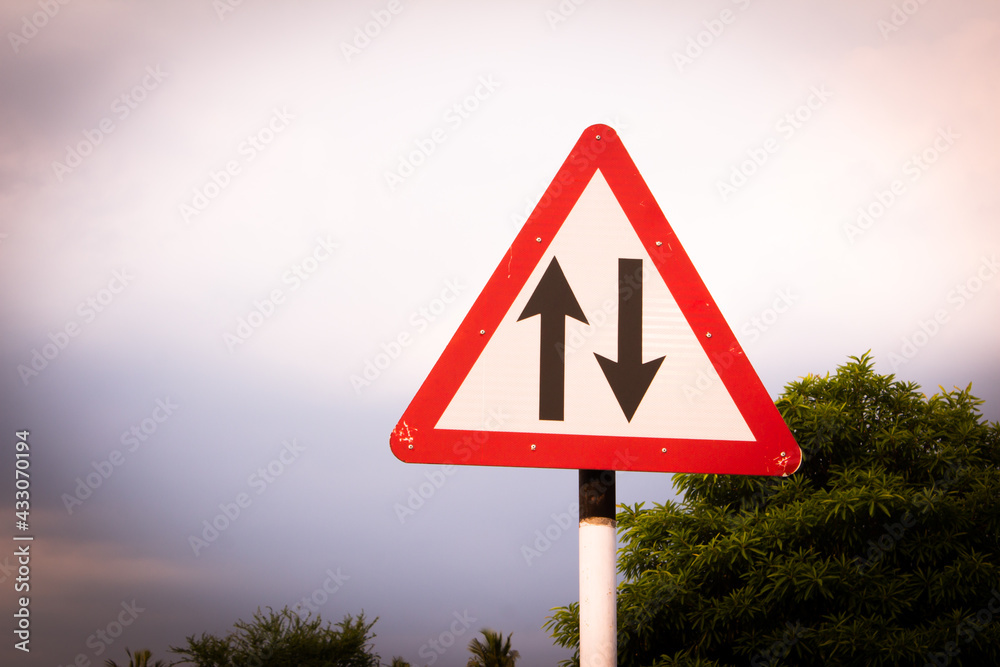 Indian road cautionary sign indicating changed pattern of traffic ...