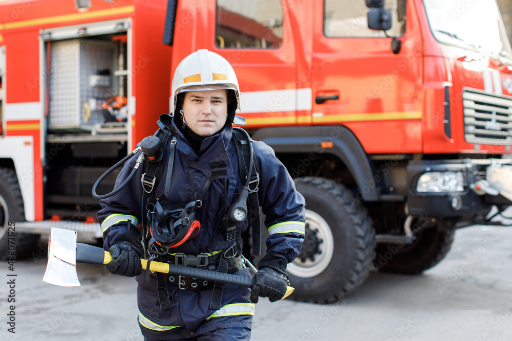 Portrait of serious and confident caucasian fireman standing and ...