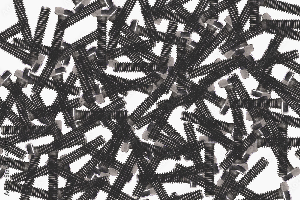 Texture formed by overlapping photographs of gray metal screws, created ...