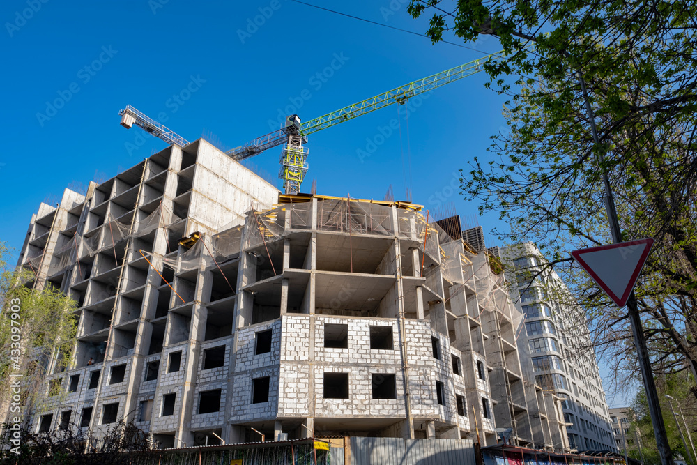 Construction of a multi-storey building, tower crane and building ...
