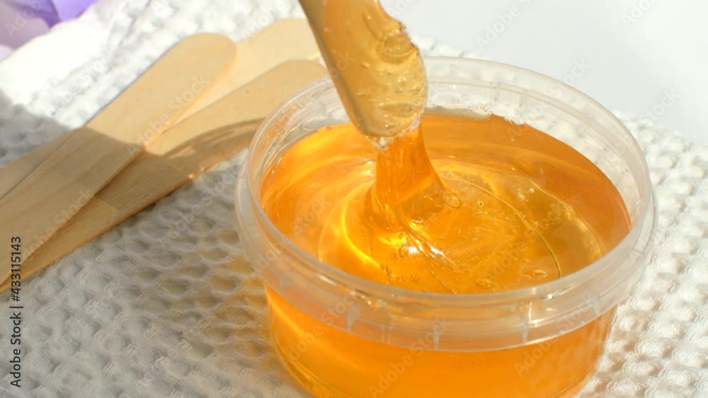 Sugar paste in a transparent jar on a white background. A master stir ...