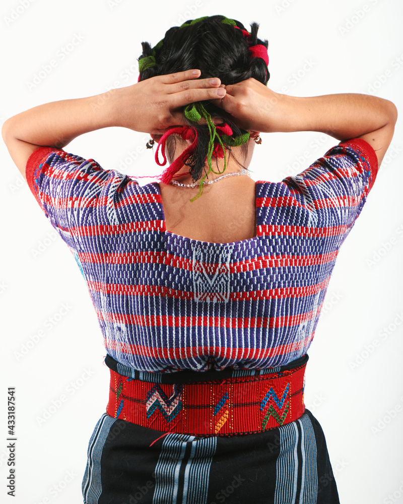 Mayan woman tie her hair with with a traditional ribbon and she's ...