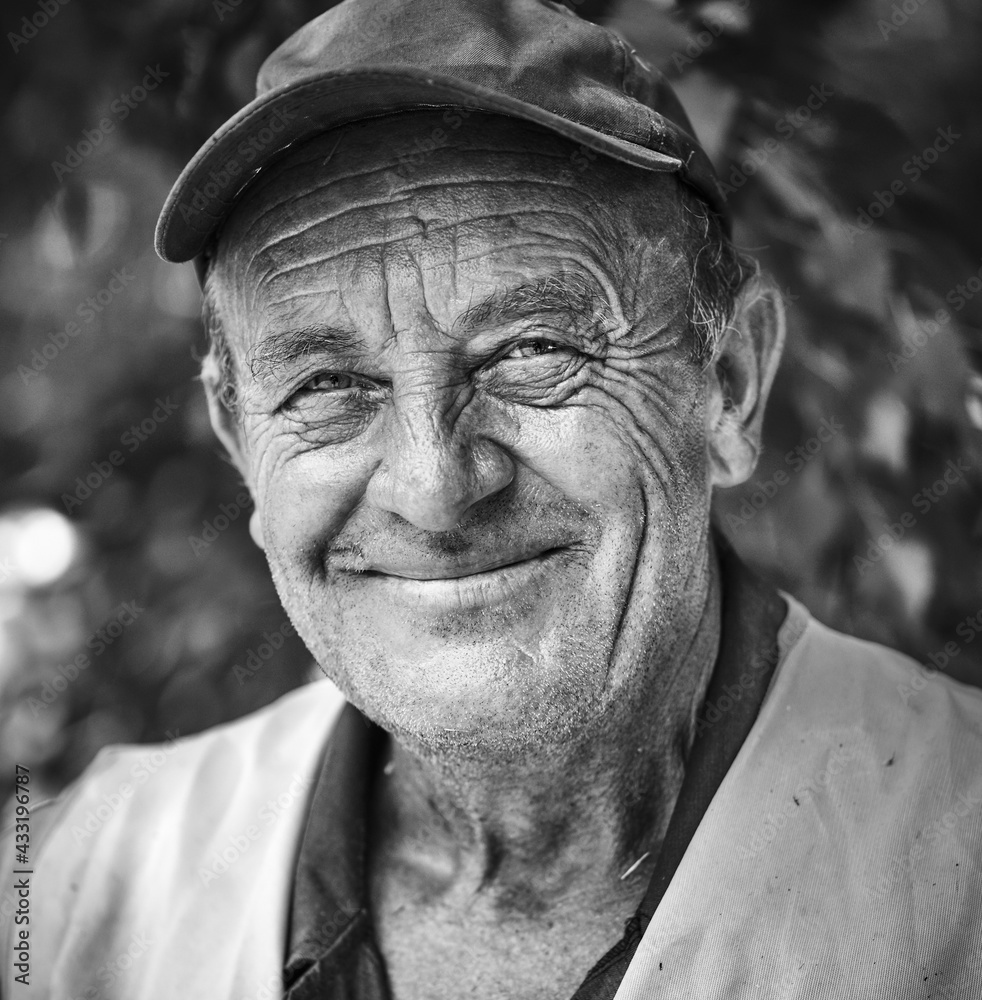 Portrait of smiling old man with wrinkled face. Black and white ...