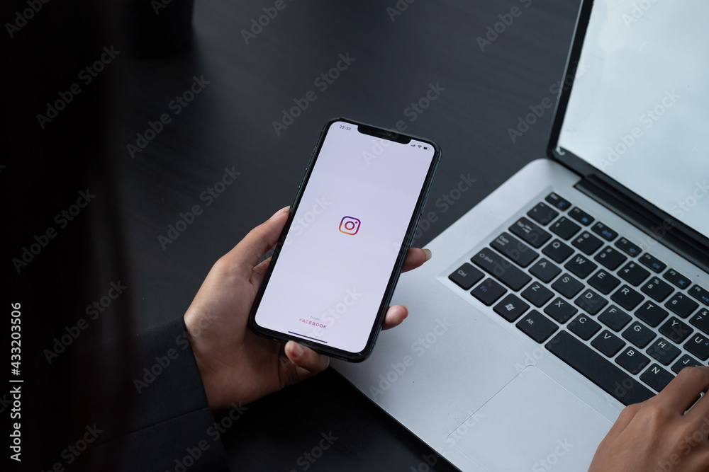 CHIANG MAI, THAILAND - APR 6 2021: Woman hand holding iphone with logo ...