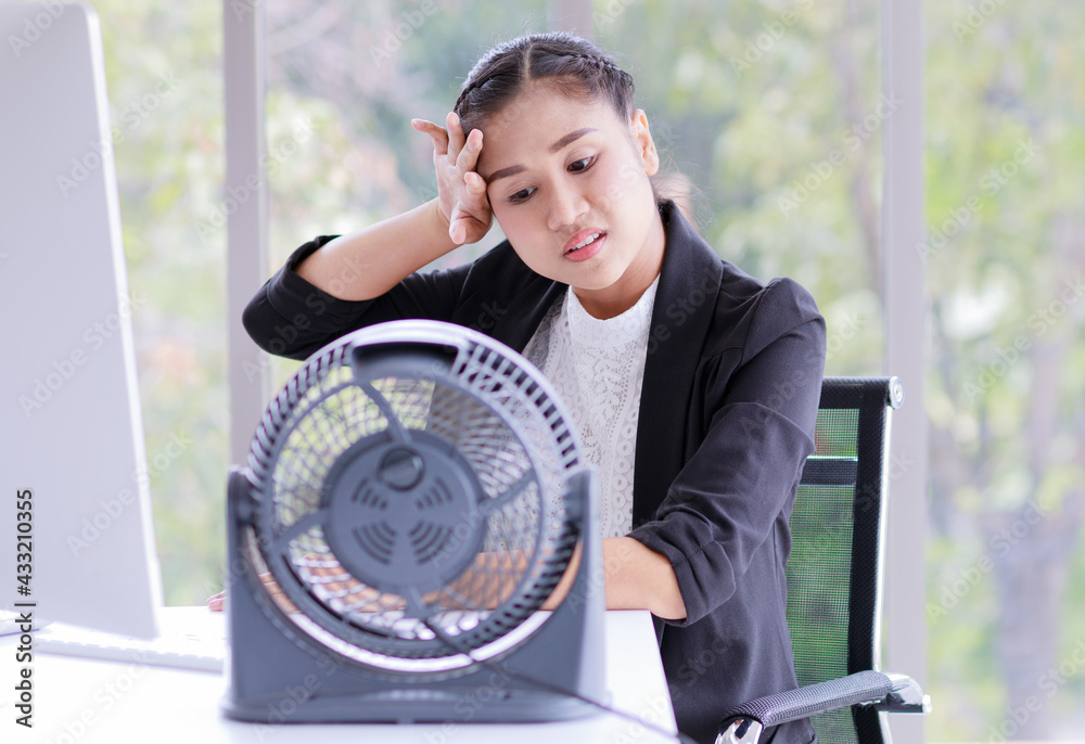 Asian female secretary feeling suffer tired and hot in summer use hand ...