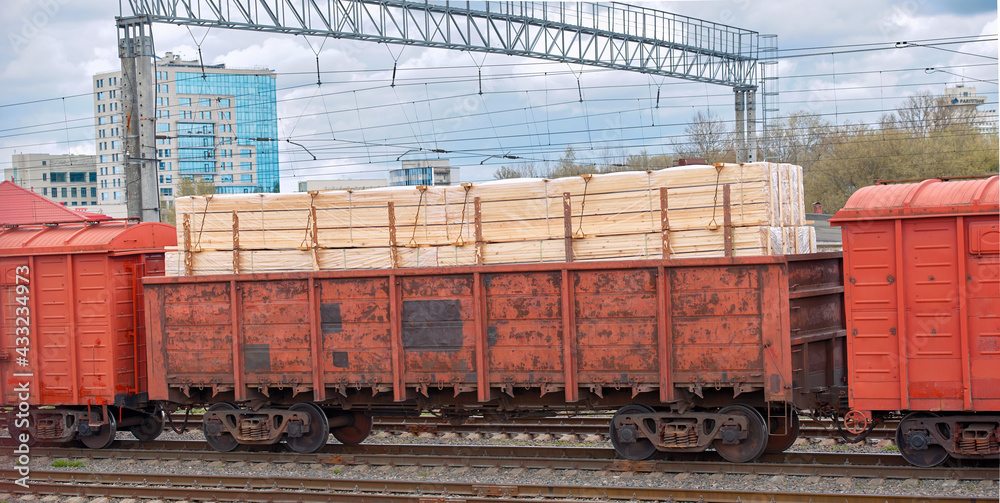Cargo transportation by rail, freight wagon with edged timber. Wagons ...