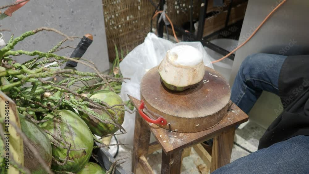 Peeling Thai coconut skin in the traditional way. Which keeping coconut ...