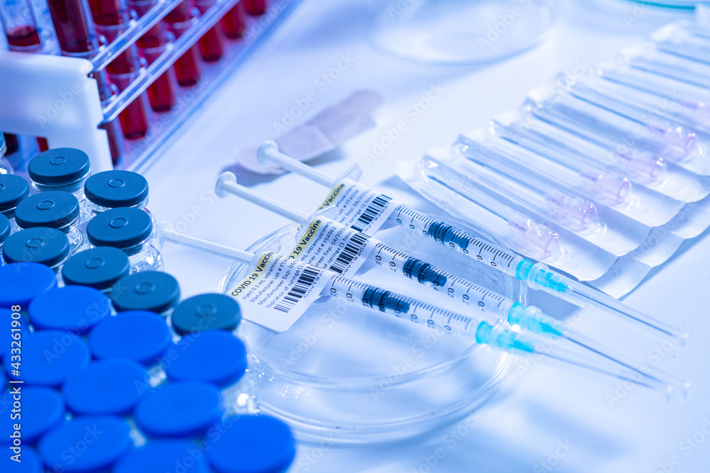 Focus on Coronavirus vaccine in ready to shot filling syringe with ...